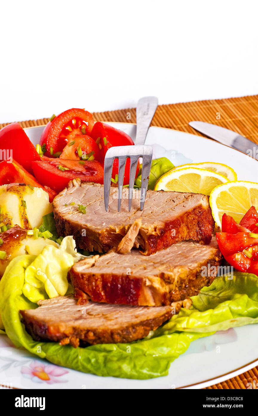 Roast with vegetables on a white background Stock Photo - Alamy