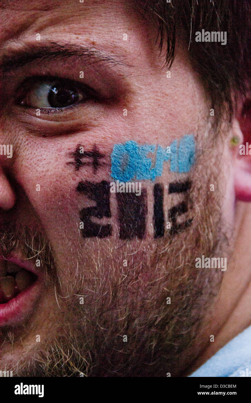 Angry student with painted face "demo 2012" looks at camera during NUS ...