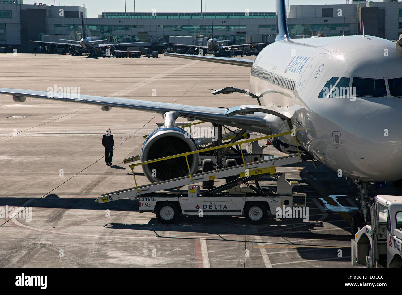 A Delta Airlines pilot does a walkaround inspection of his aircraft ...