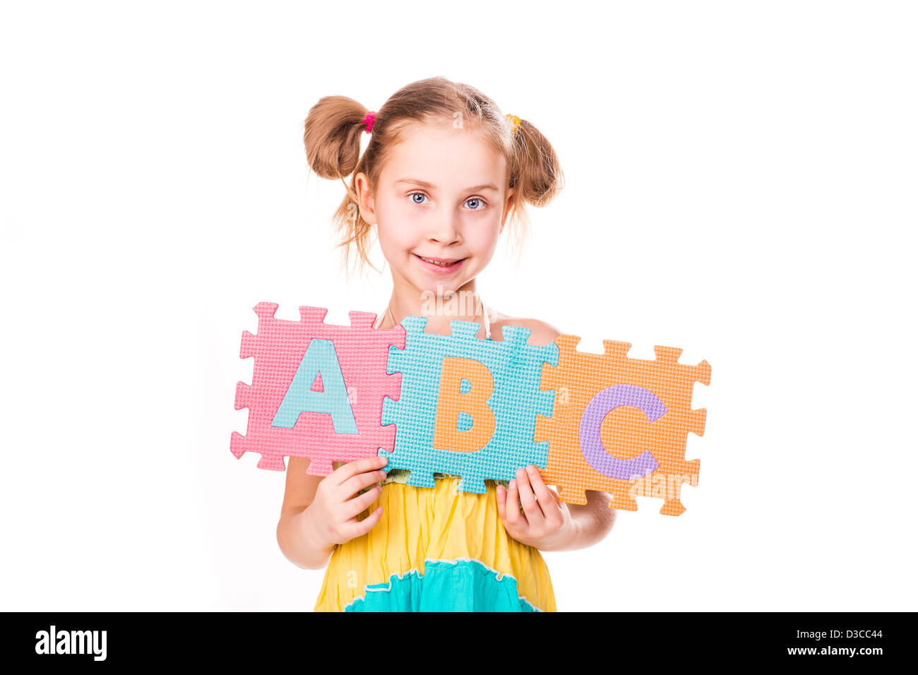 Happy girl holding alphabet letters ABC isolated on white Stock Photo ...