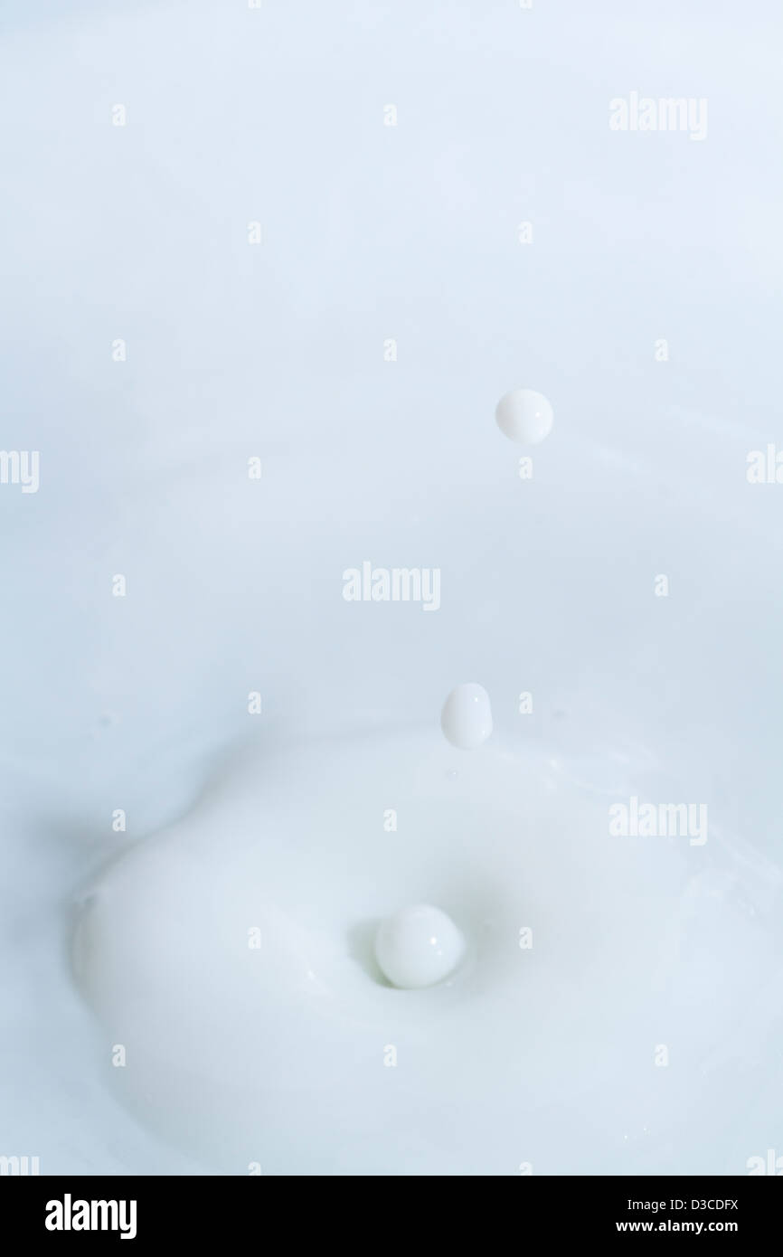 Close view of a droplet of milk hitting a surface of milk Stock Photo ...
