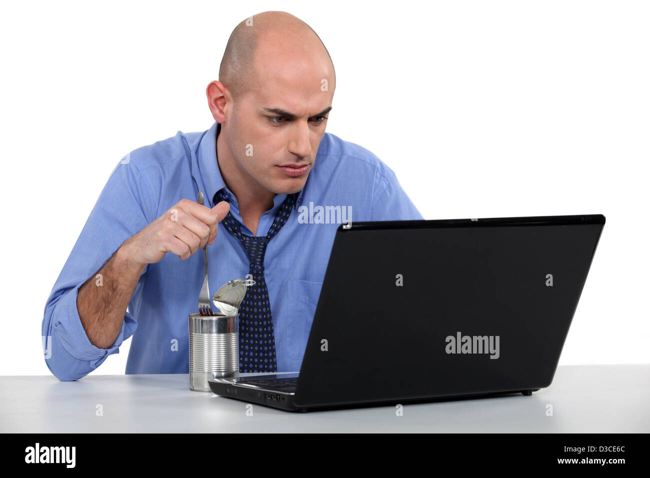 Businessman eating out of tin can Stock Photo - Alamy