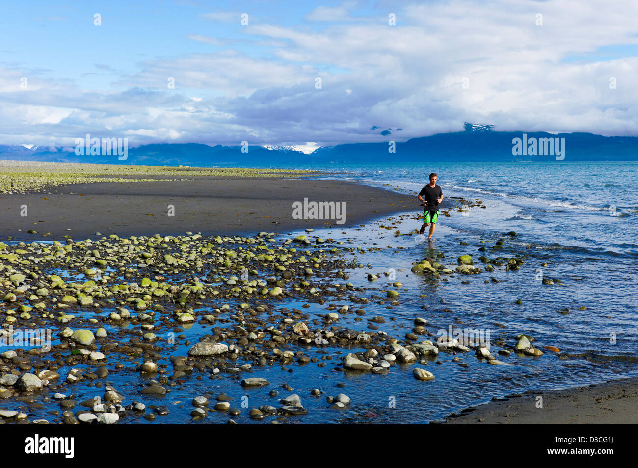 Man running hard on Bishop Beach, Homer, Alaska, USA Stock Photo - Alamy