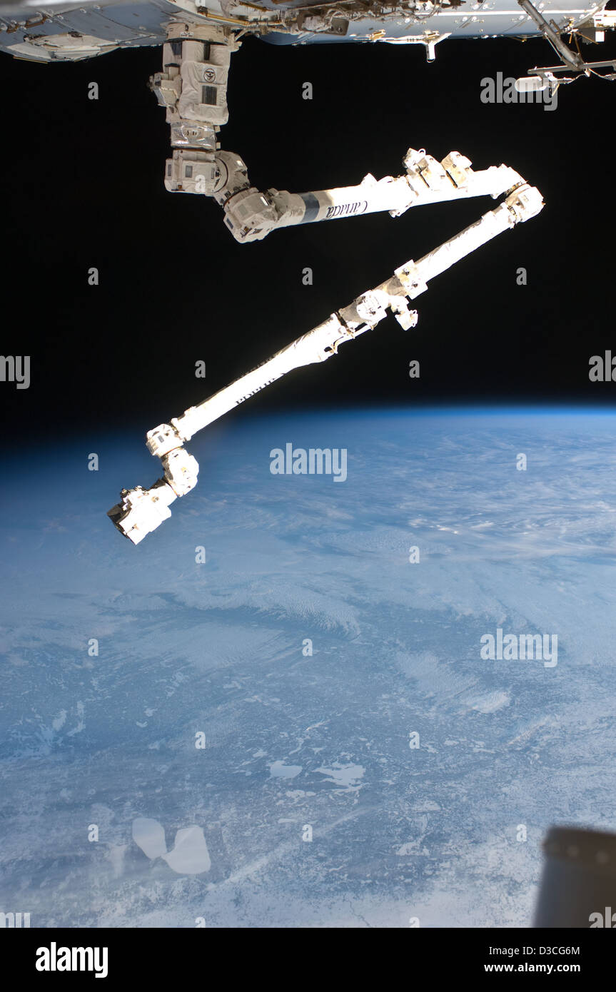 The Canadarm2 robotic arm is shown above Earth during a Crew Earth ...