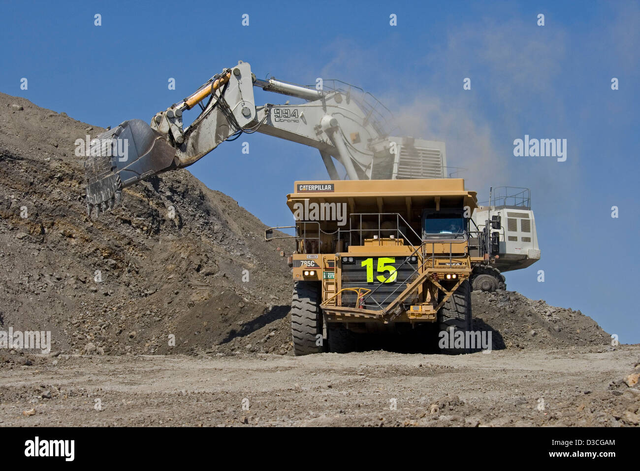 Excavator loading soil into tip truck at open cut coal mine in central ...