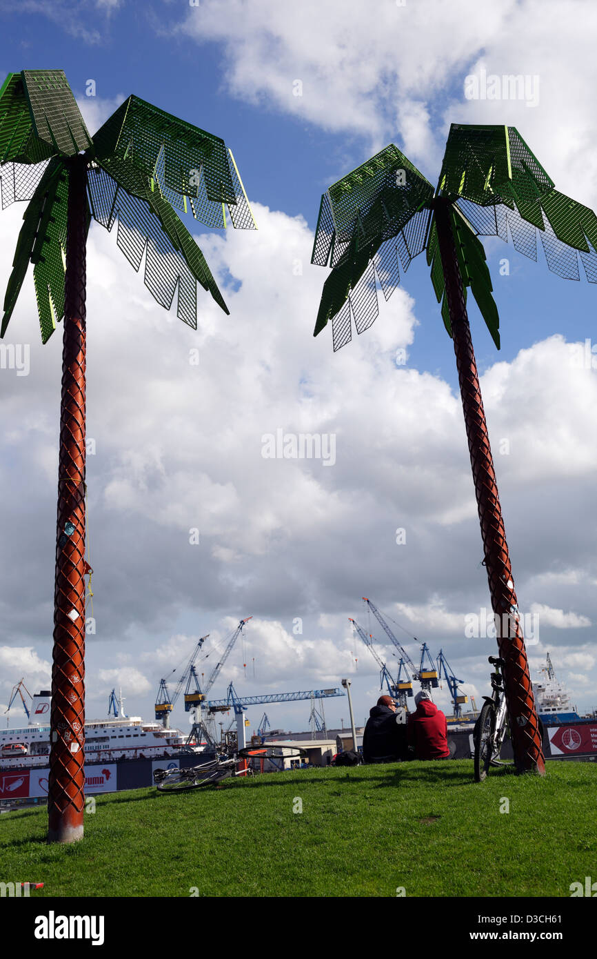 Hamburg, Germany, young people sitting under artificial palm trees in ...