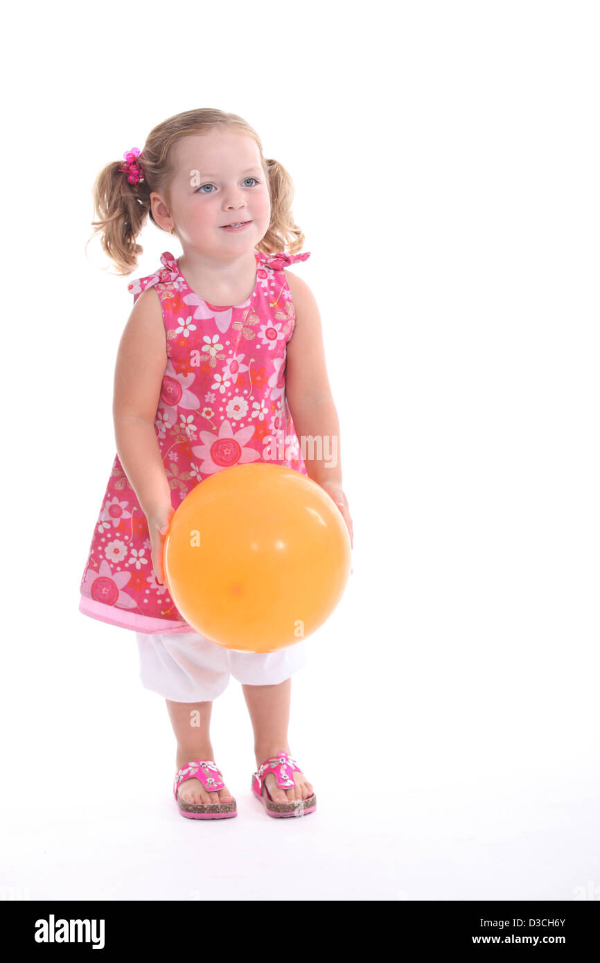 Studio shot of a little girl with a balloon Stock Photo - Alamy