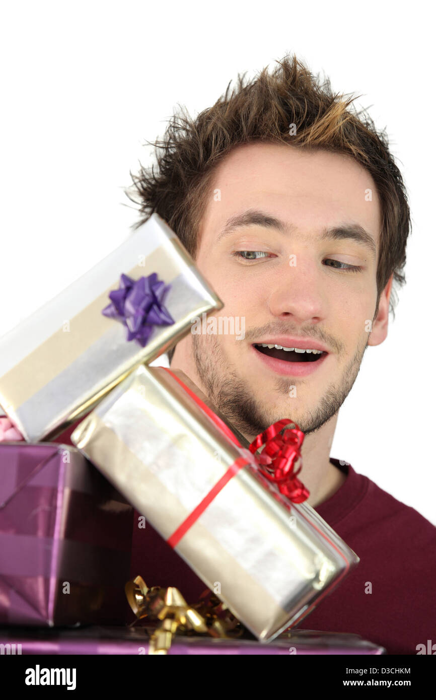 Man holding pile of presents Stock Photo - Alamy