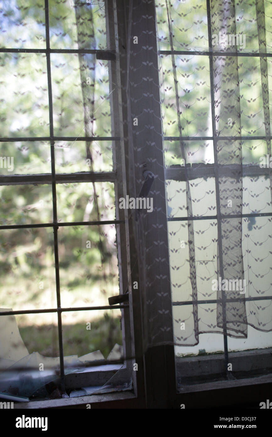 Gross Dölln, Germany, barred window with curtains in a former barracks ...