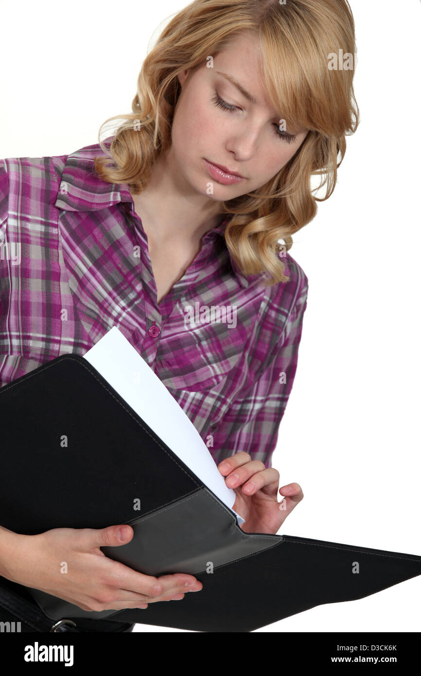 A cute blond looking through papers Stock Photo - Alamy