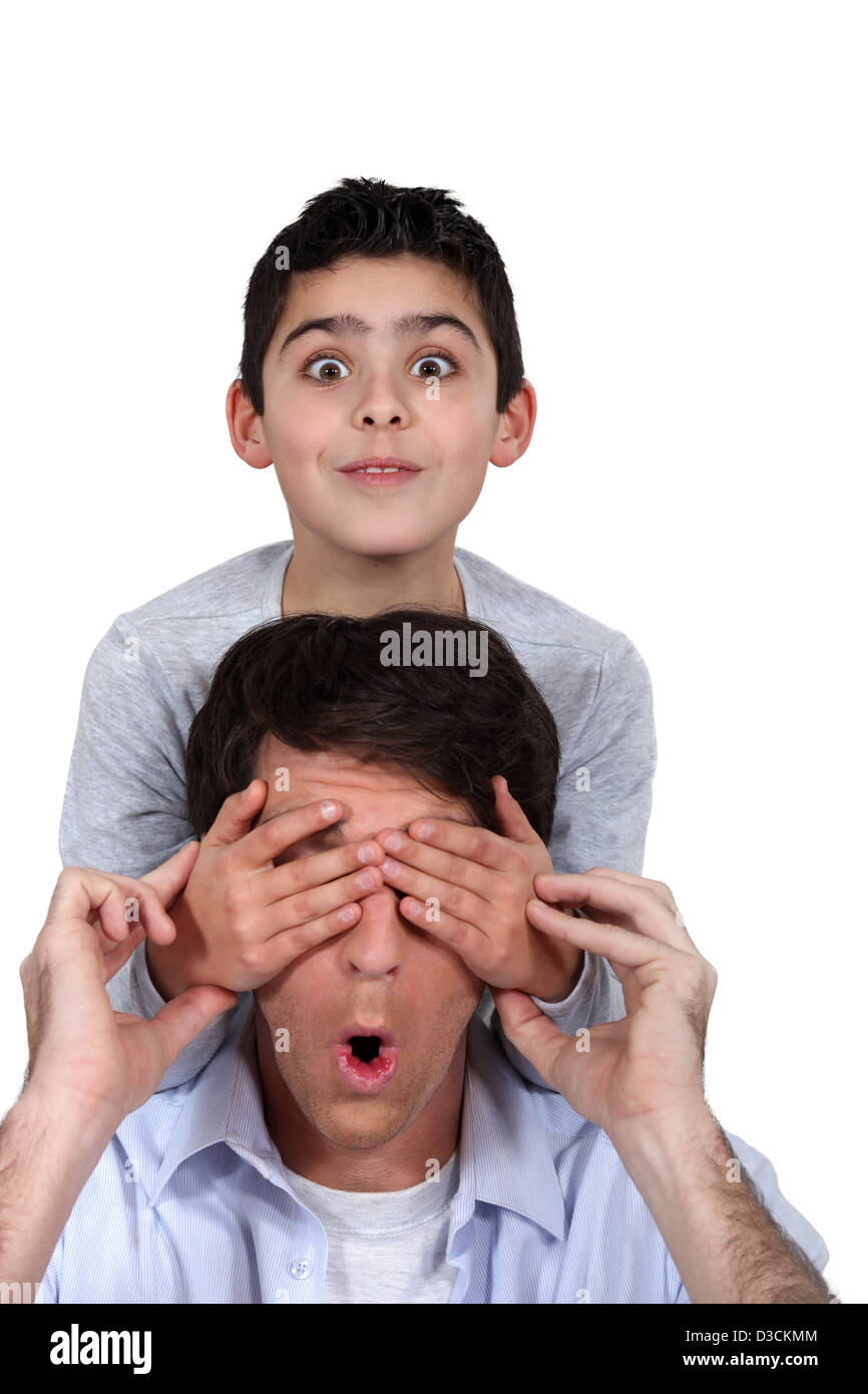 Child covering parent's eyes Stock Photo - Alamy