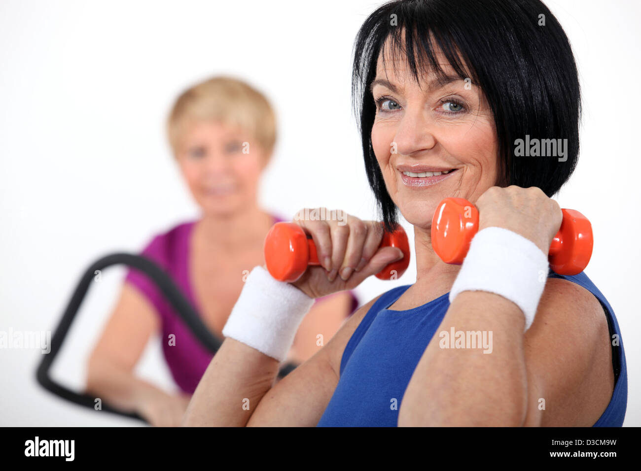 Two women working out in the gym Stock Photo - Alamy