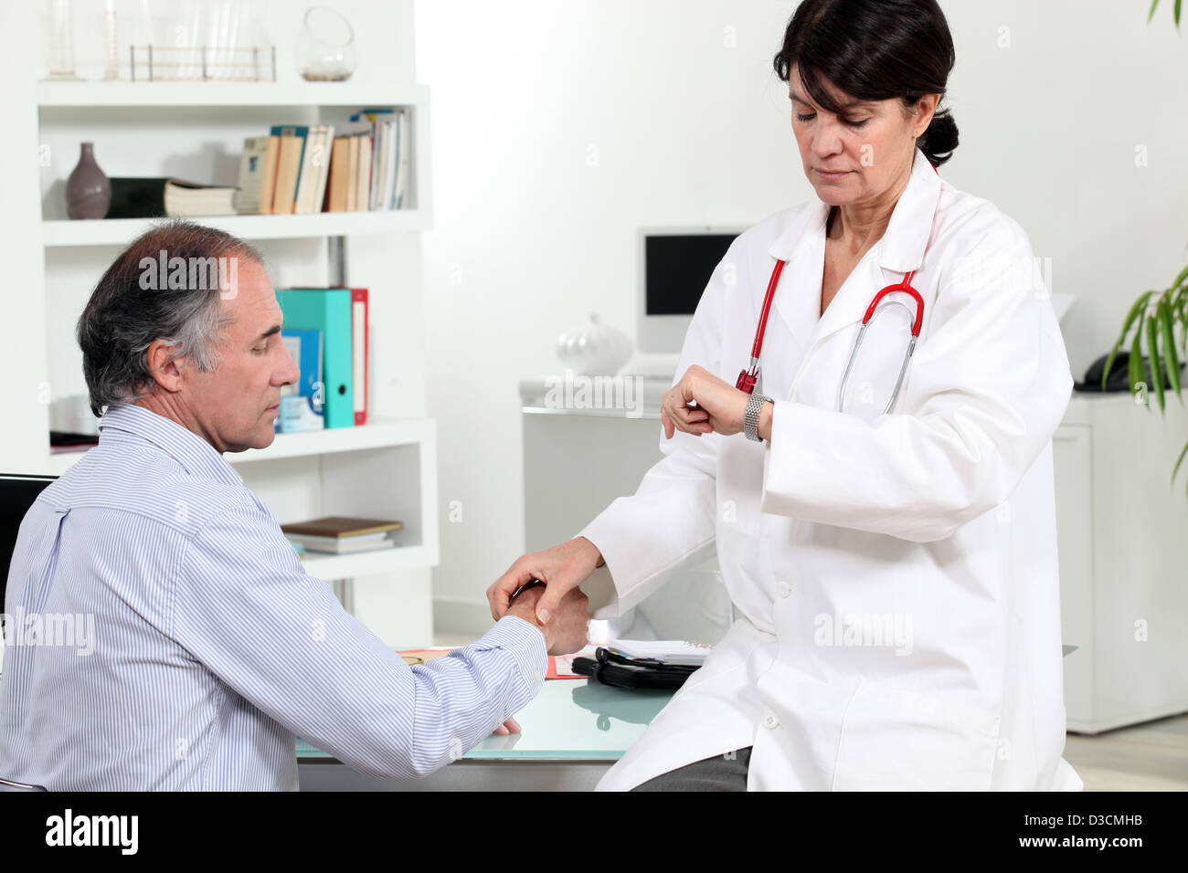 A doctor taking her patient pulse rate Stock Photo - Alamy