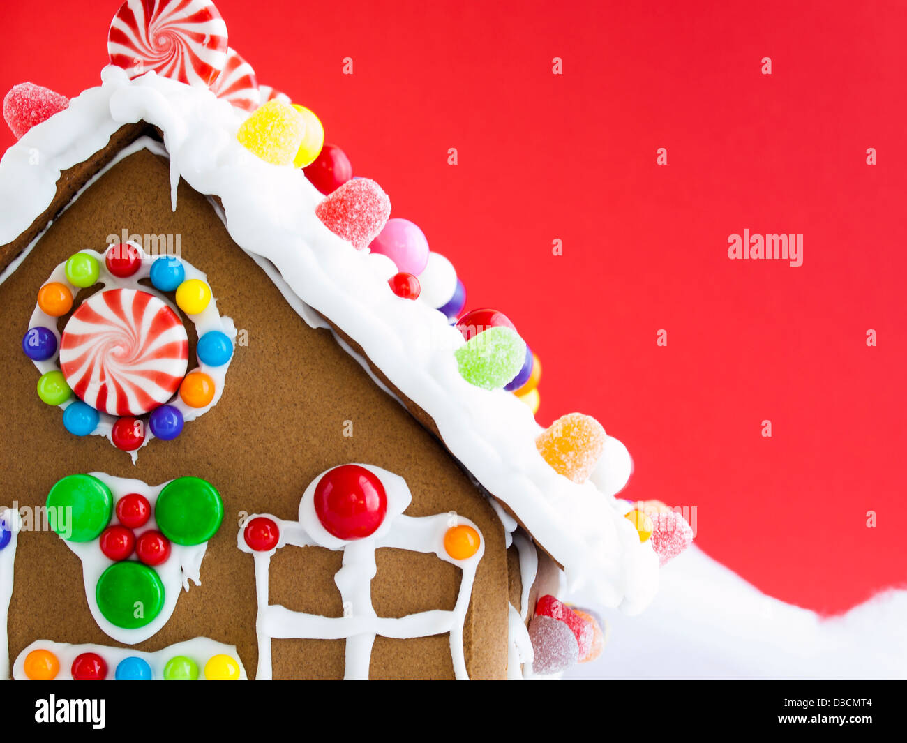 Decorated gingerbread house on red background Stock Photo - Alamy