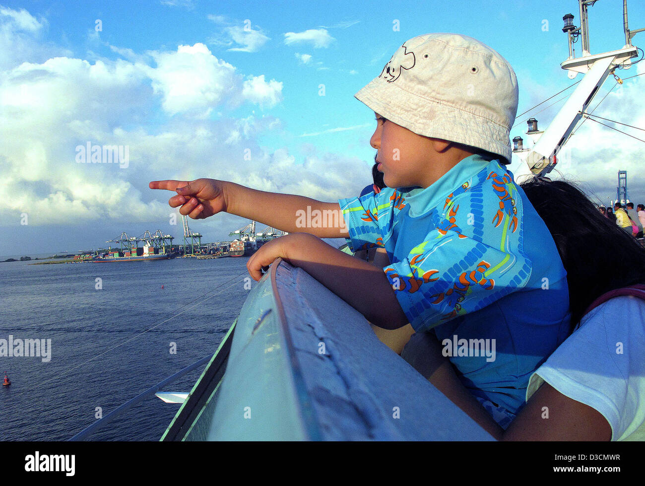 Dec 12, 2012 - Colon, Panama - A boy and his mother look at cargo ships ...