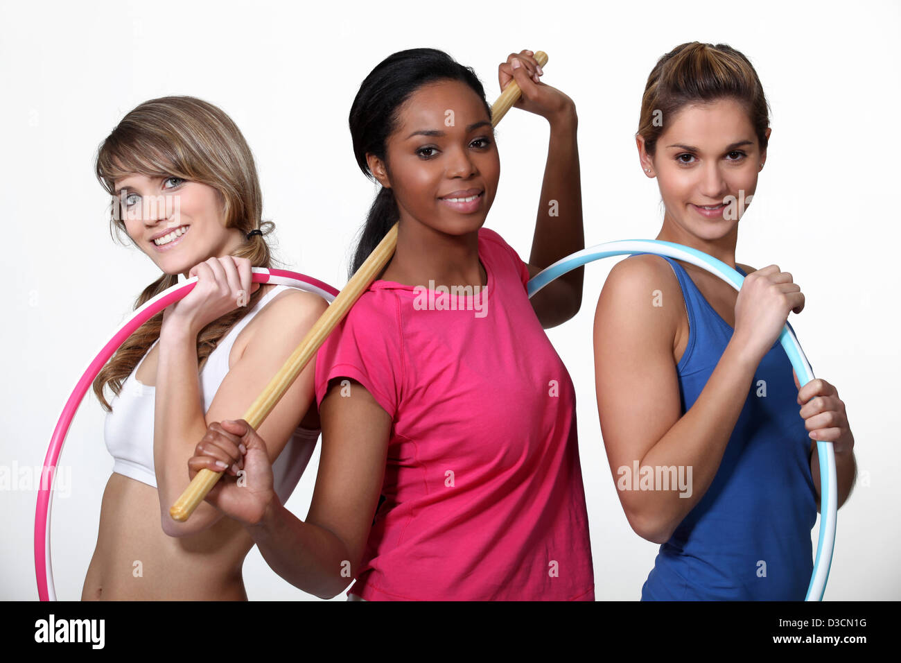 Three women limbering up at the gym Stock Photo - Alamy