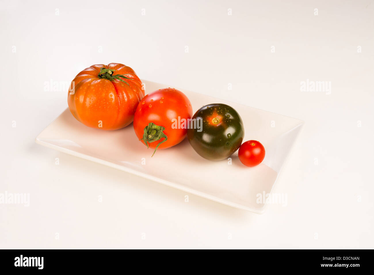 A small assortment of differently sized and colored tomatoes Stock ...