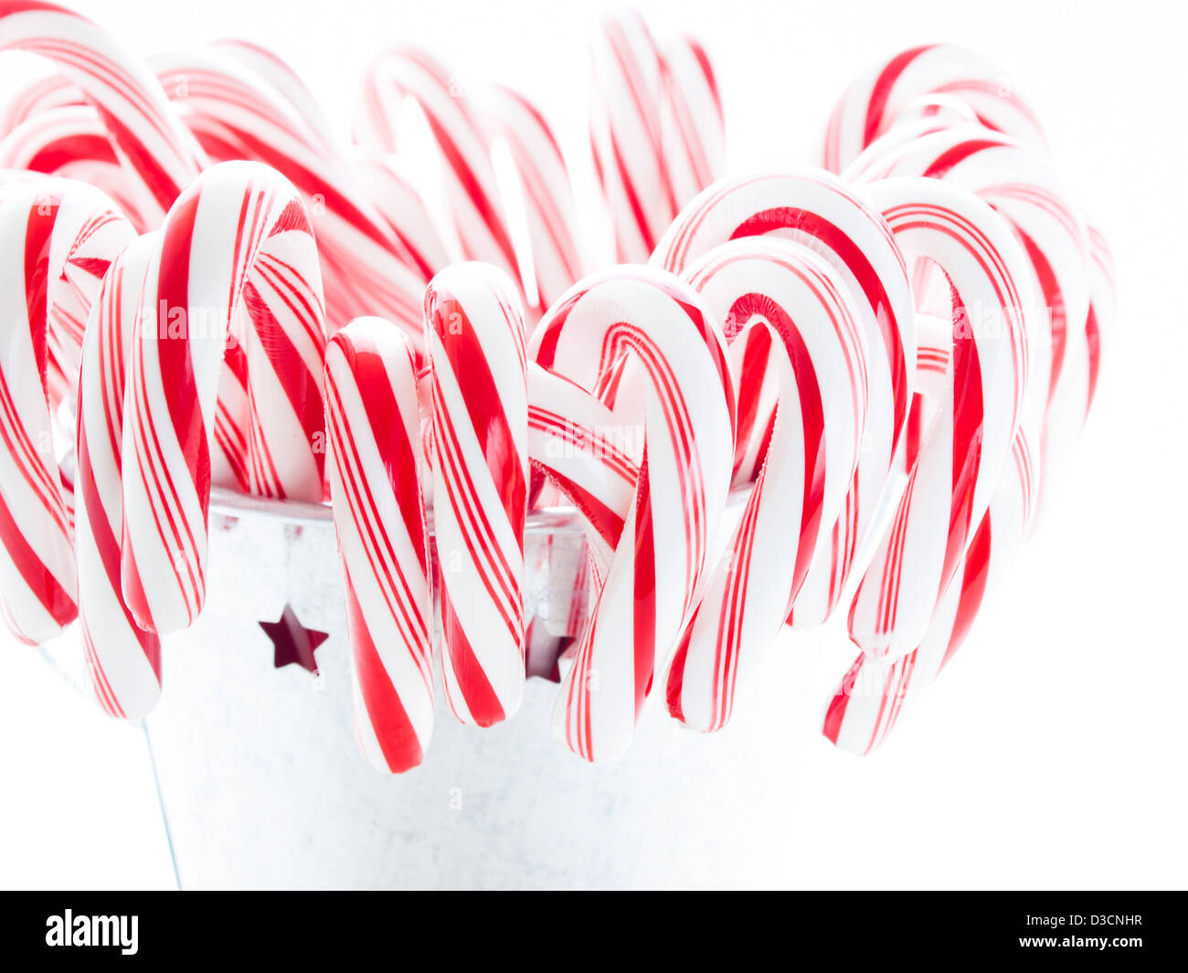 Peppermint candy canes in metal bucket on white background Stock Photo ...
