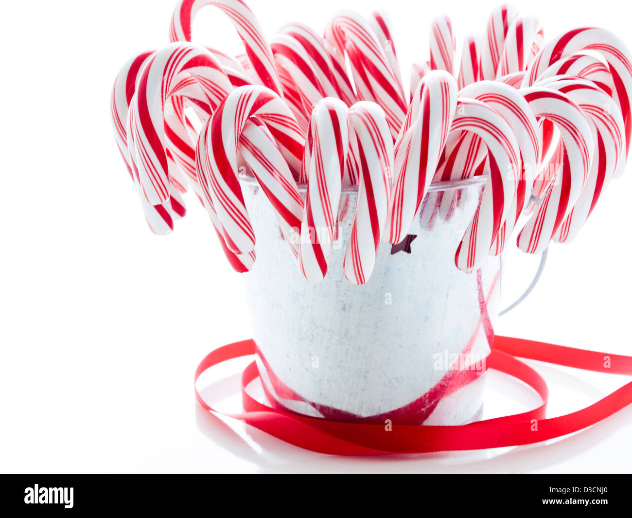 Peppermint candy canes in metal bucket on white background Stock Photo ...