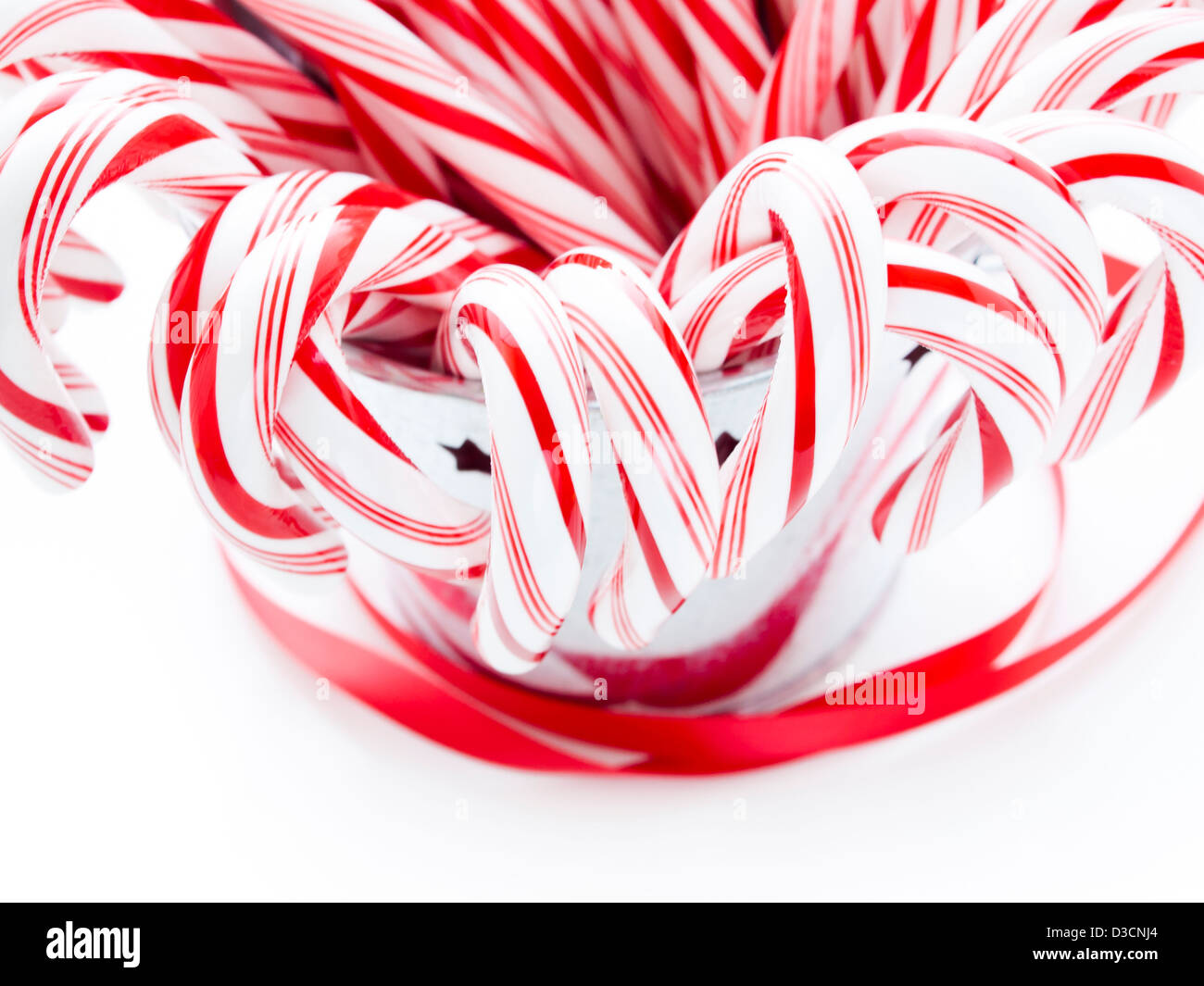 Peppermint candy canes in metal bucket on white background Stock Photo ...