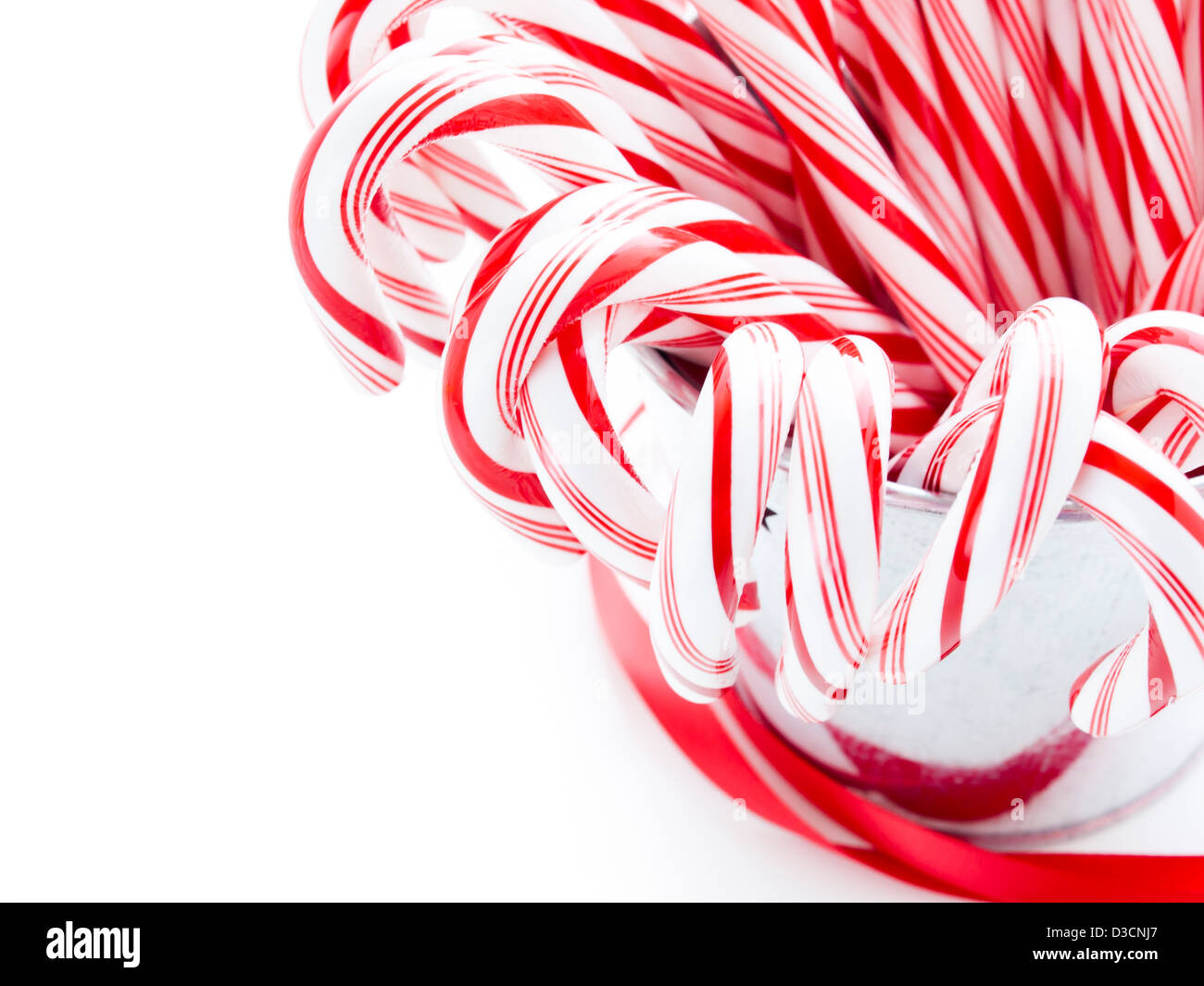 Peppermint candy canes in metal bucket on white background Stock Photo ...