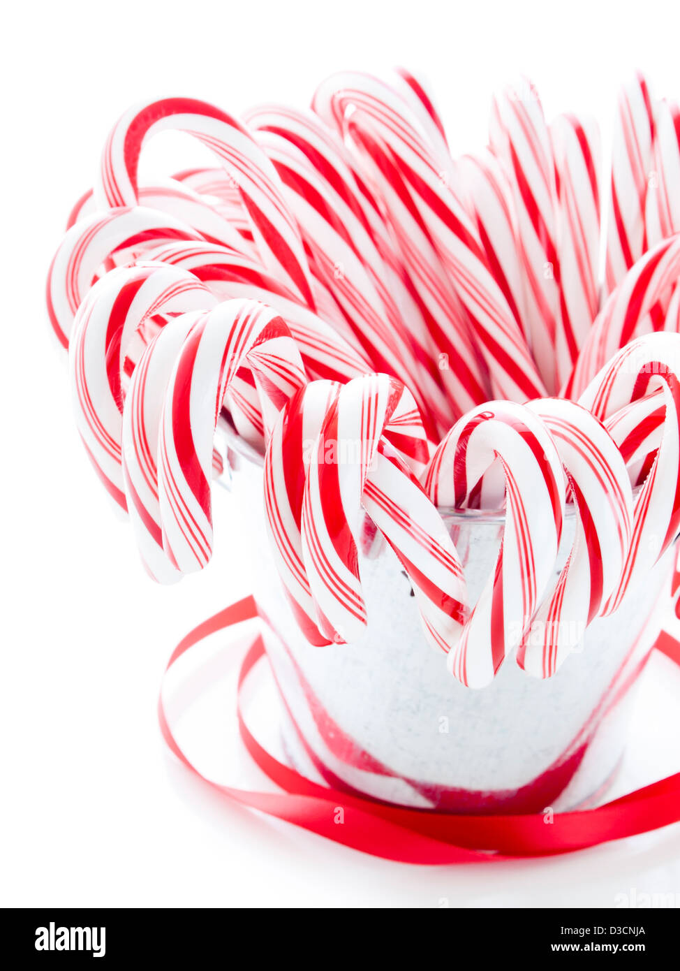 Peppermint candy canes in metal bucket on white background Stock Photo ...