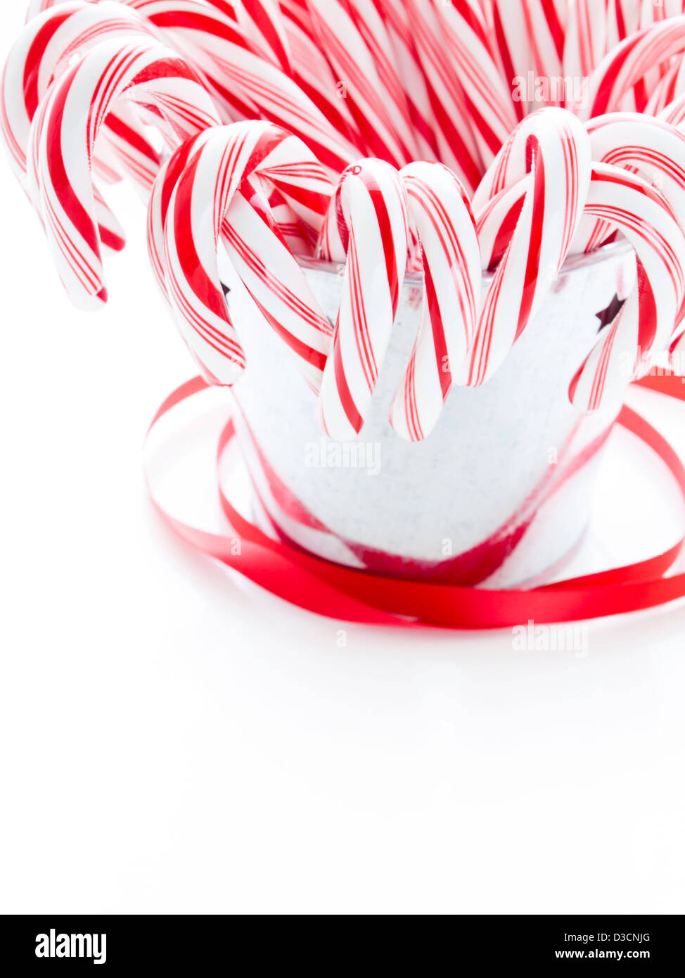 Peppermint candy canes in metal bucket on white background Stock Photo ...