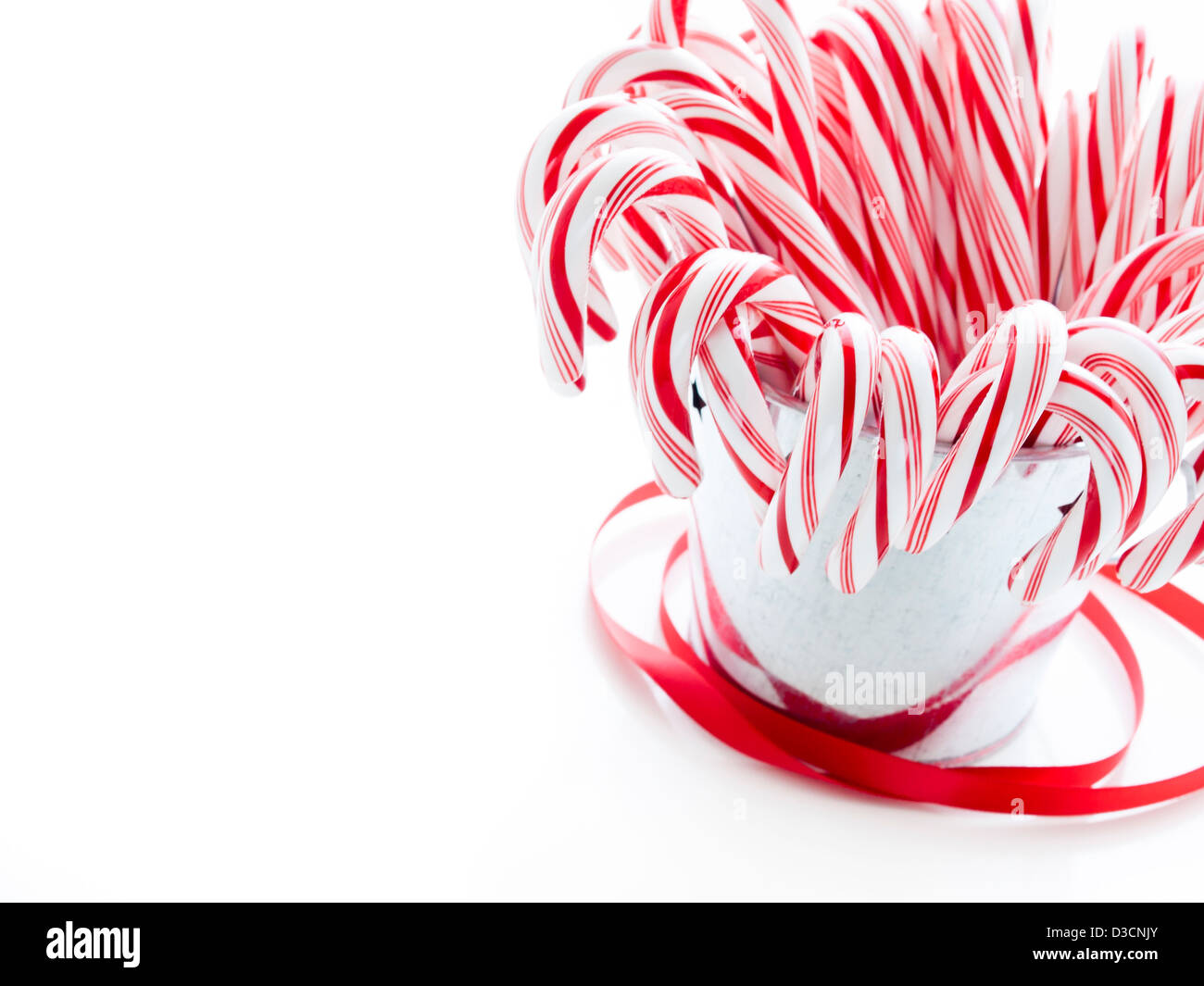 Peppermint candy canes in metal bucket on white background Stock Photo ...