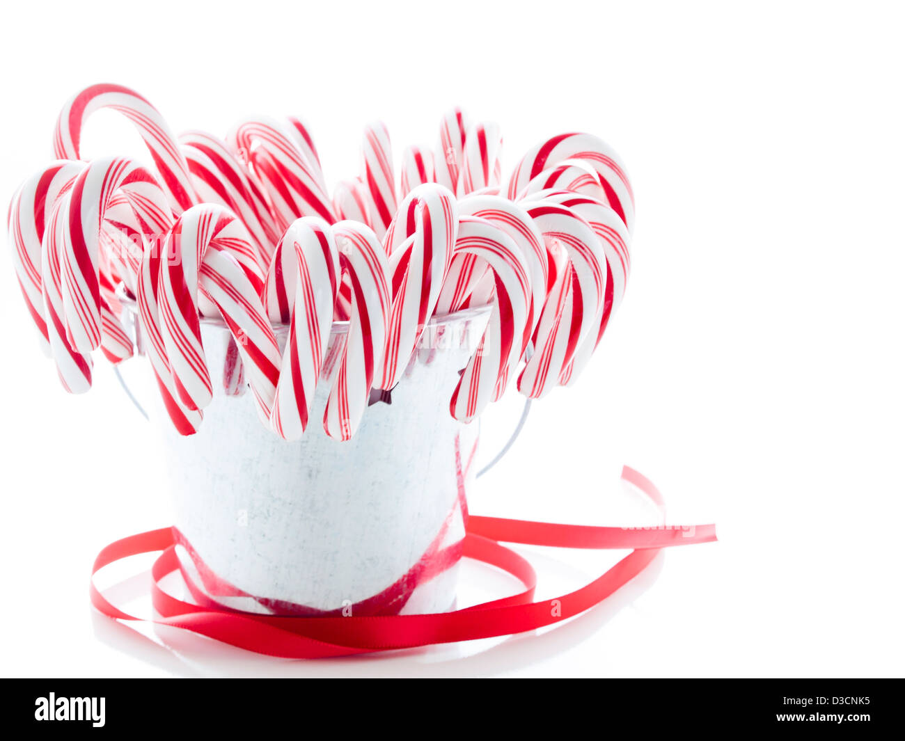 Peppermint candy canes in metal bucket on white background Stock Photo ...