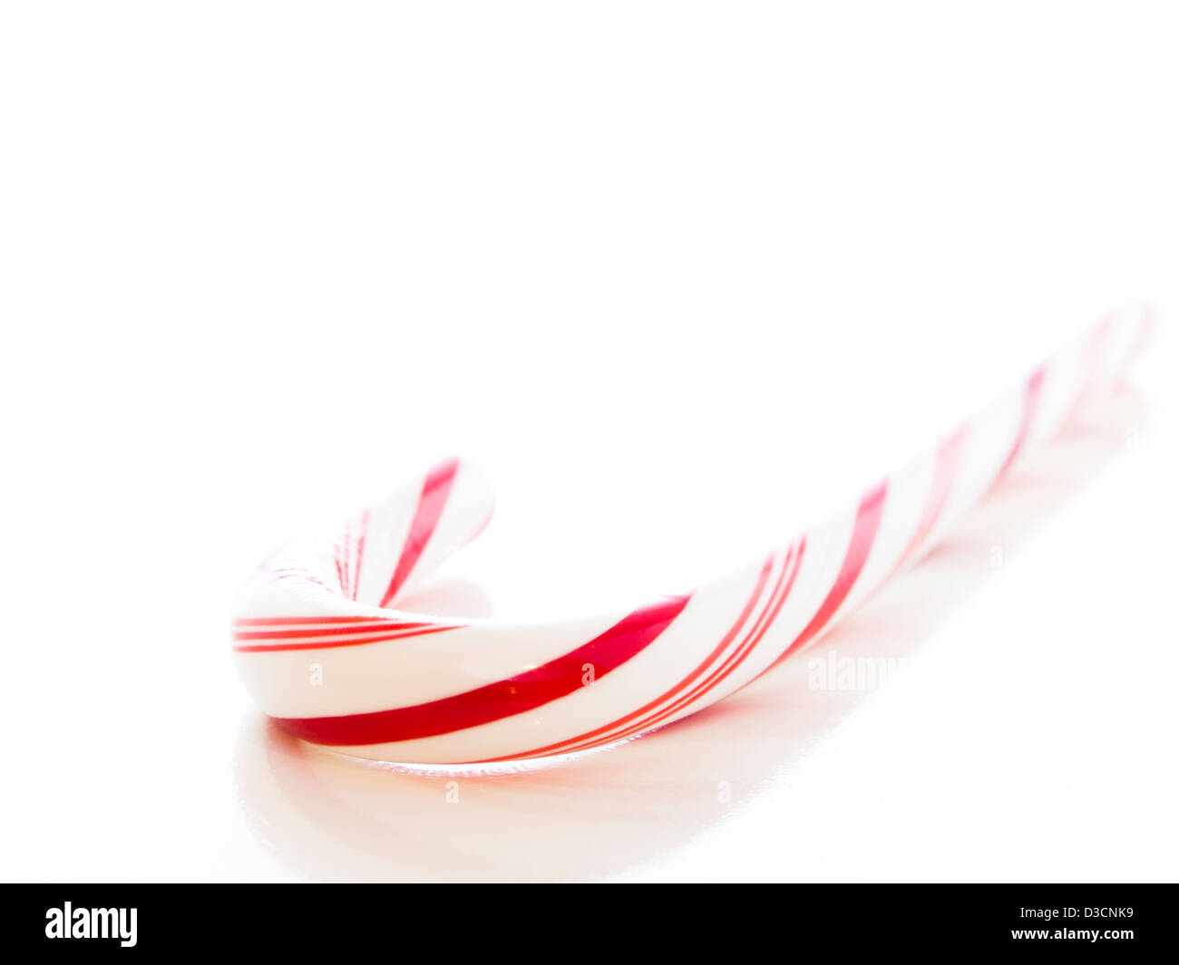 White and red peppermint candy cane on white background Stock Photo - Alamy