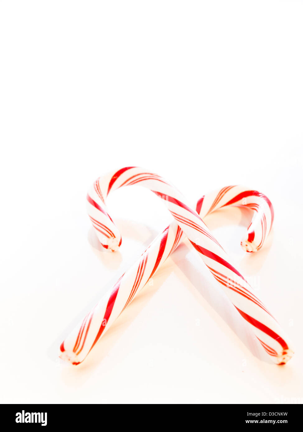 White and red peppermint candy cane on white background Stock Photo - Alamy