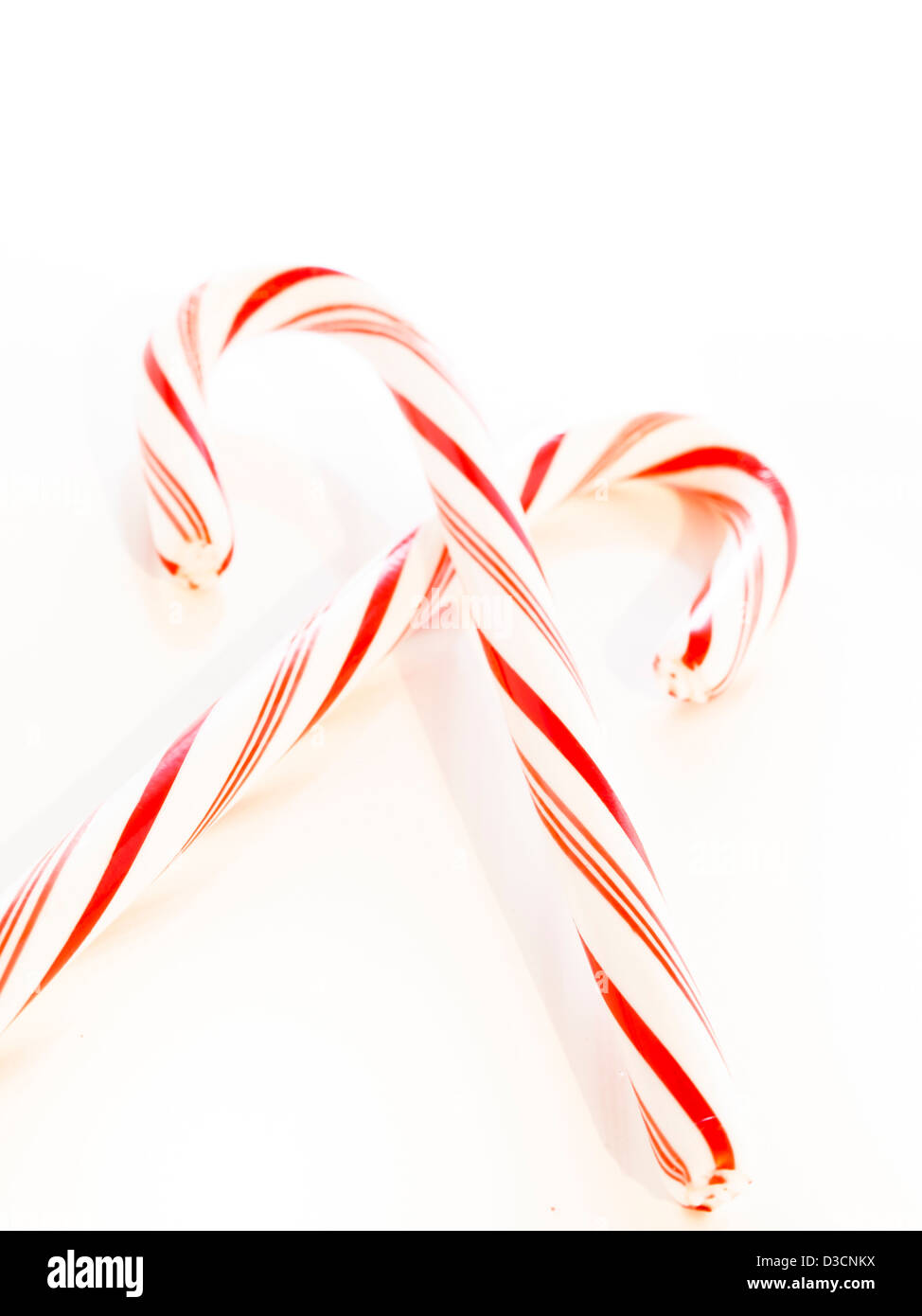 White and red peppermint candy cane on white background Stock Photo - Alamy