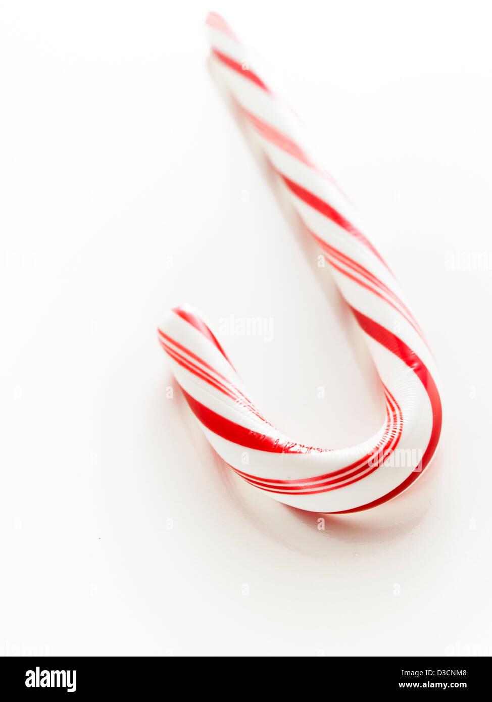 White and red peppermint candy cane on white background Stock Photo - Alamy