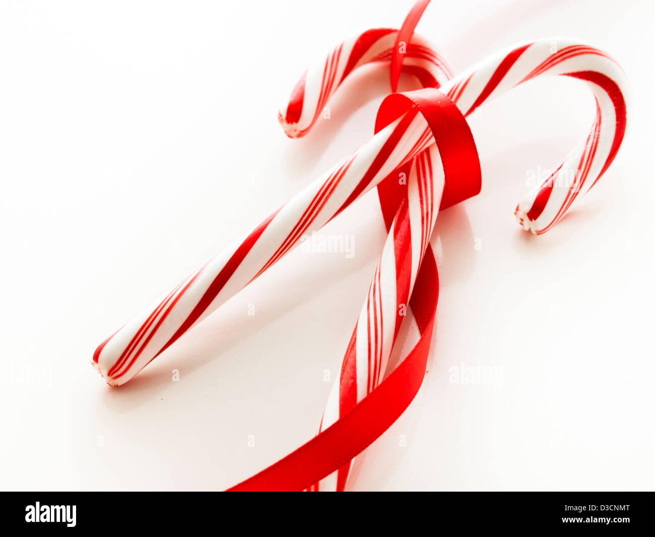 White and red peppermint candy cane on white background Stock Photo - Alamy