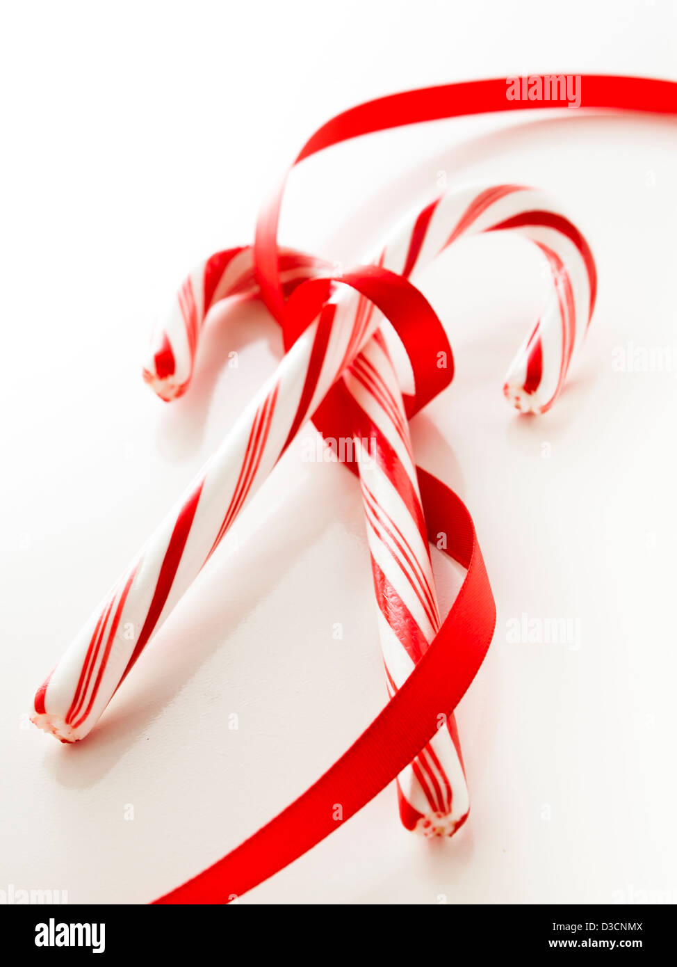 White and red peppermint candy cane on white background Stock Photo - Alamy