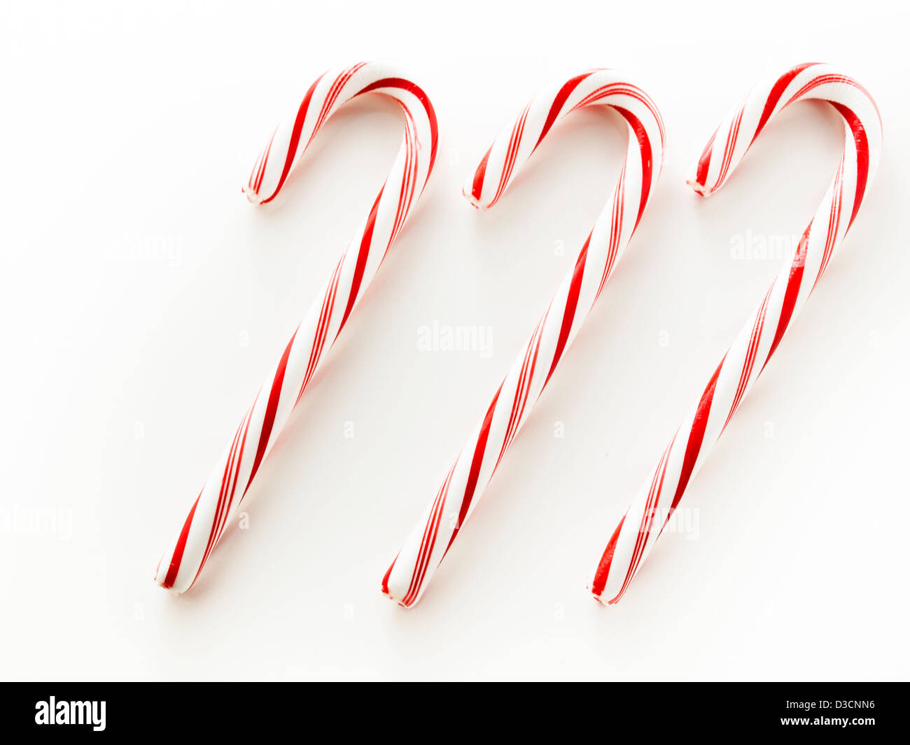 White and red peppermint candy cane on white background Stock Photo - Alamy