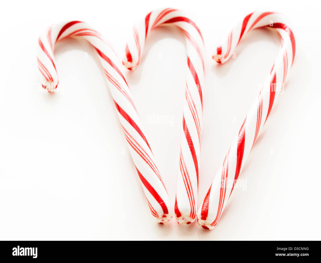 White and red peppermint candy cane on white background Stock Photo - Alamy