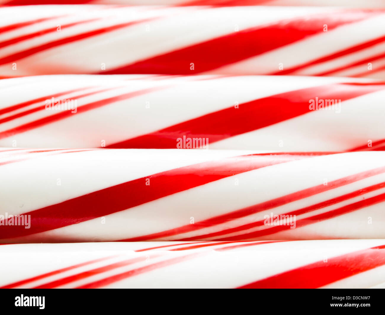 White and red peppermint candy canes in a row on white background Stock ...