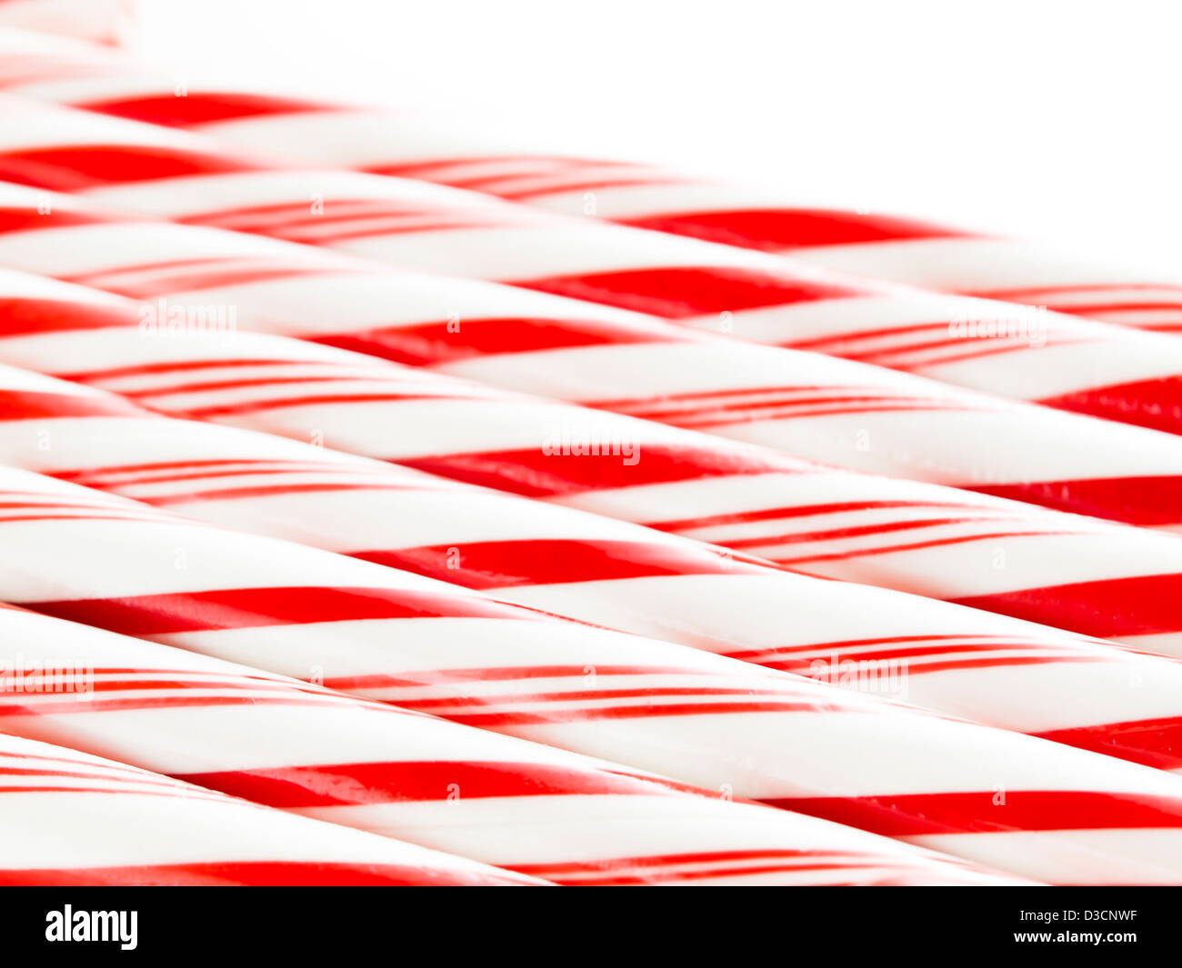 White and red peppermint candy canes in a row on white background Stock ...