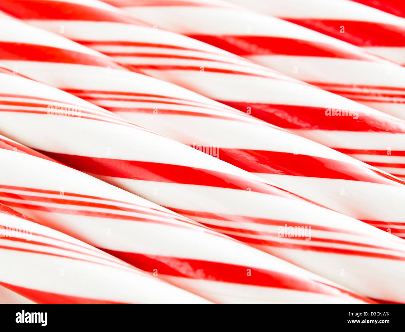 White and red peppermint candy canes in a row on white background Stock ...