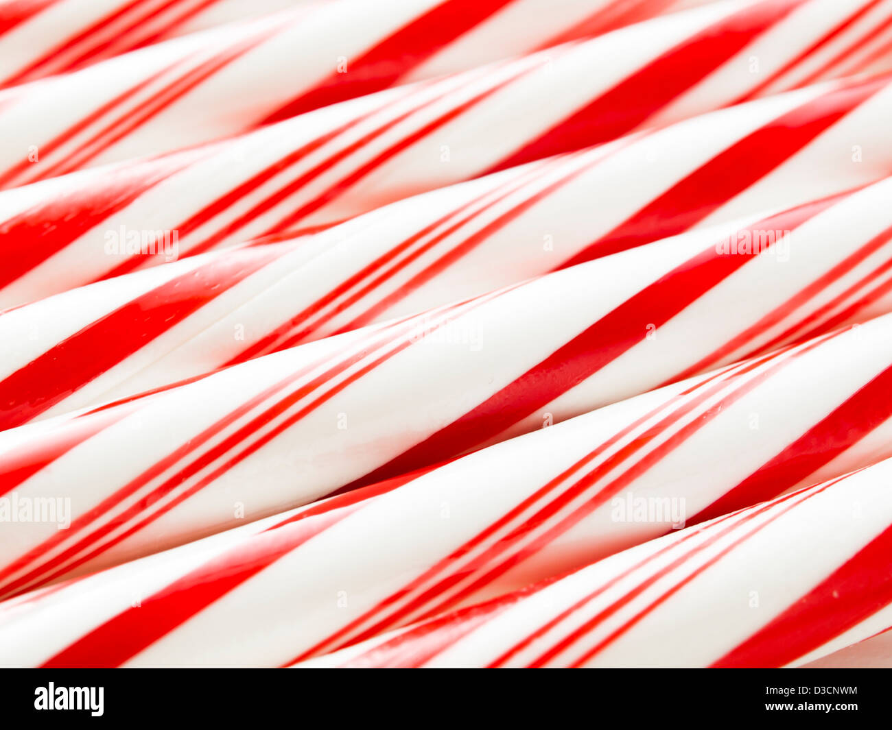 White and red peppermint candy canes in a row on white background Stock ...