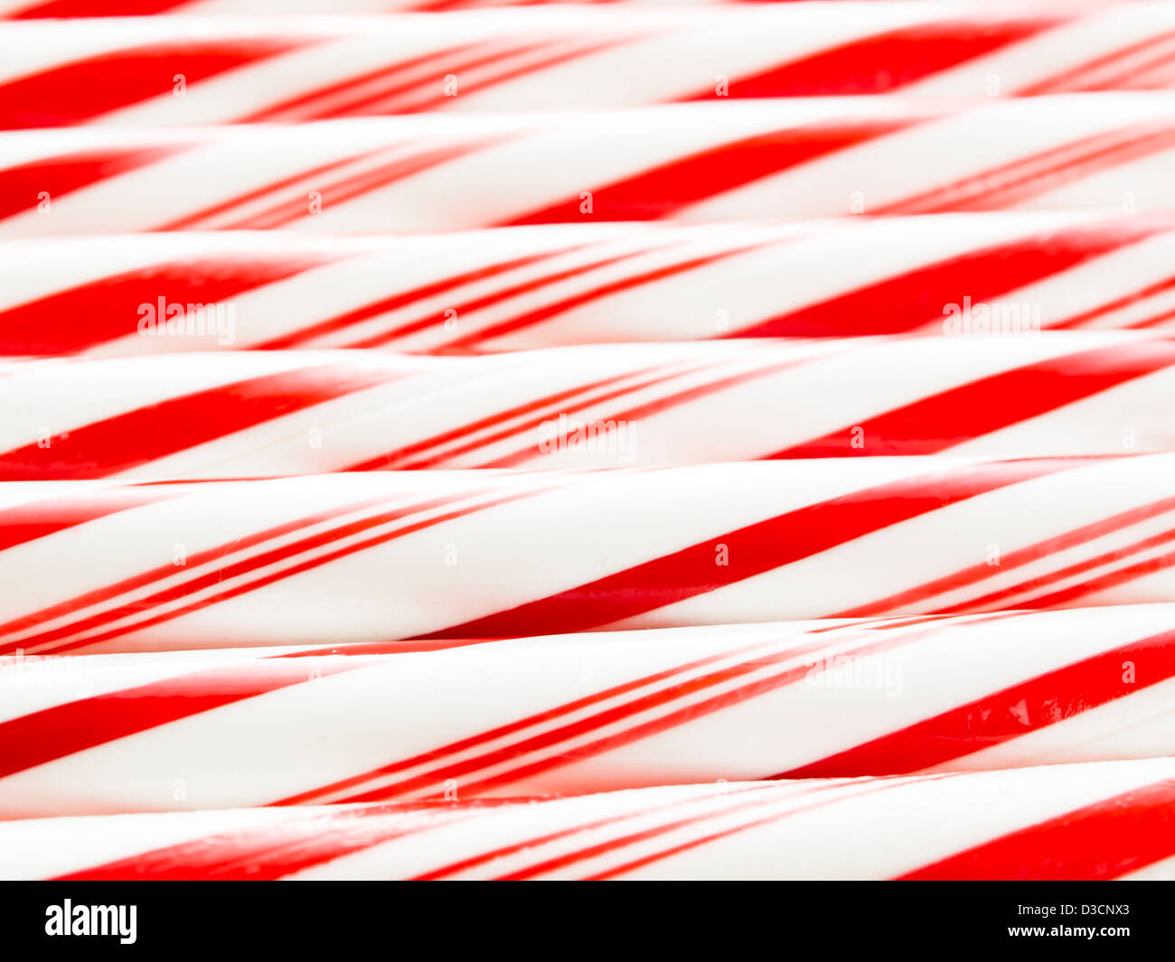 White and red peppermint candy canes in a row on white background Stock ...