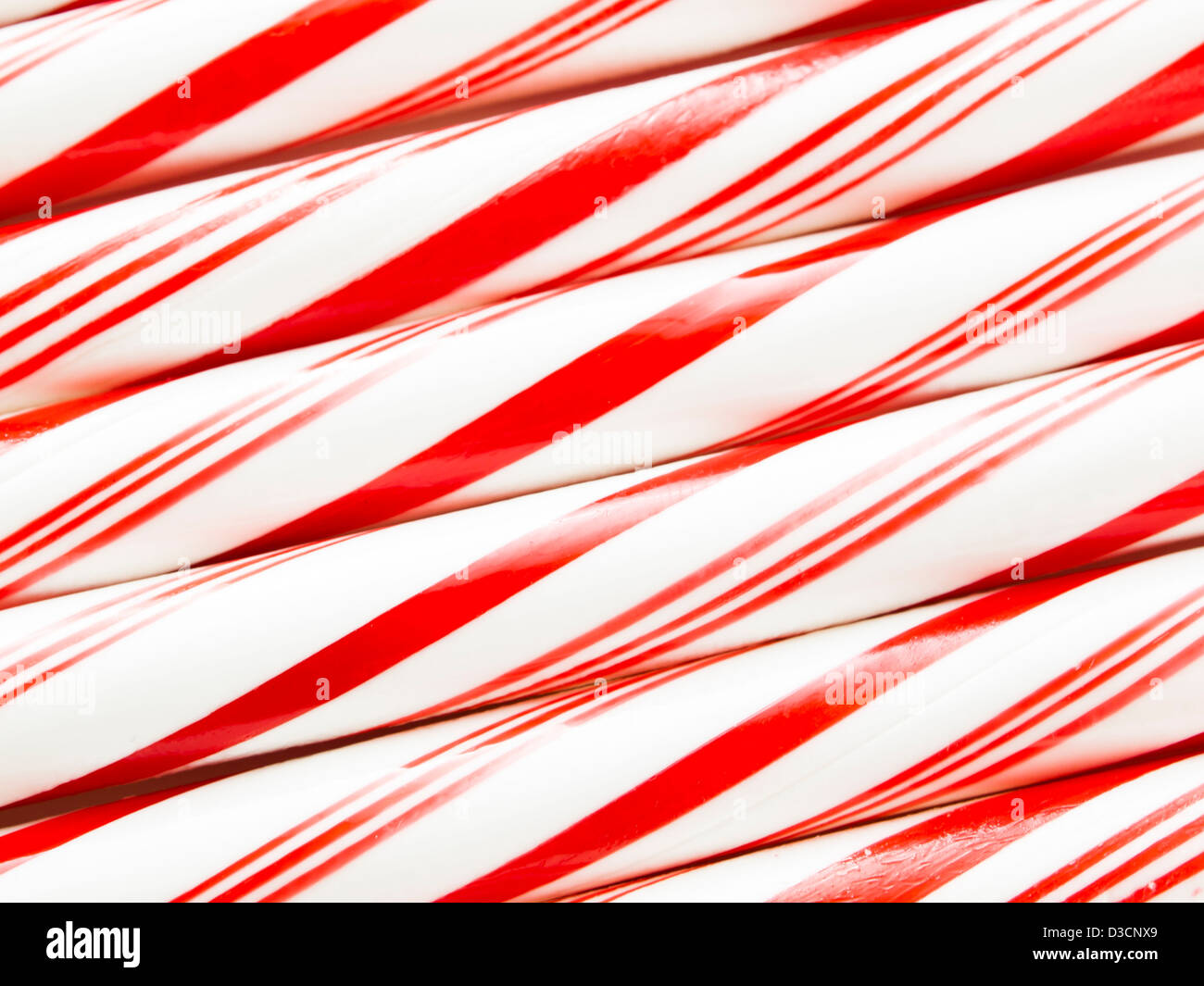 White and red peppermint candy canes in a row on white background Stock ...