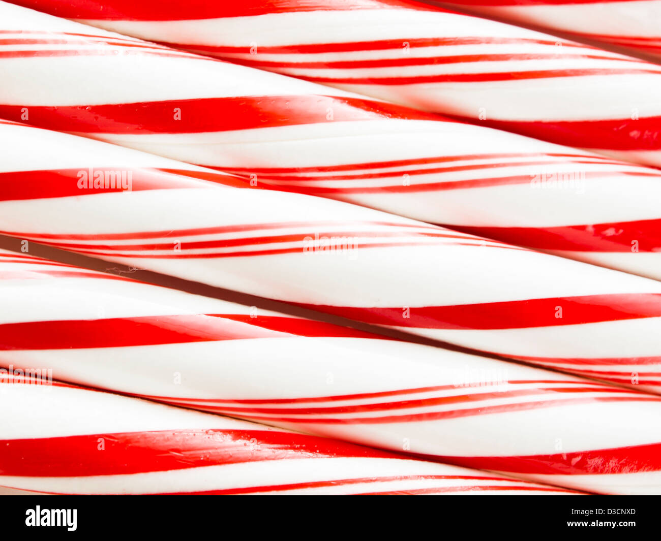 White and red peppermint candy canes in a row on white background Stock ...