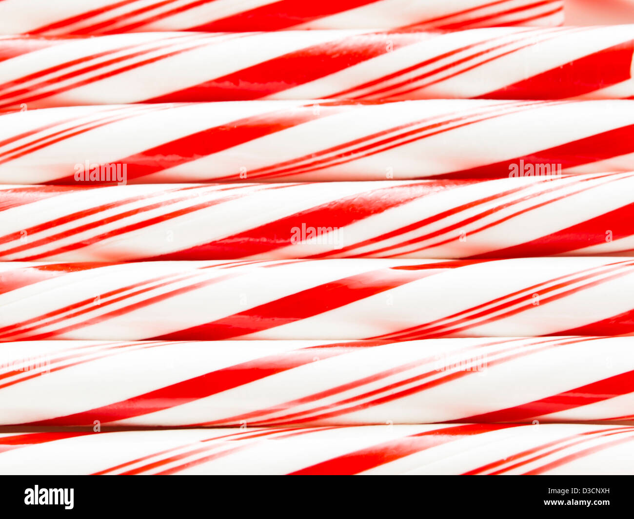 White and red peppermint candy canes in a row on white background Stock ...