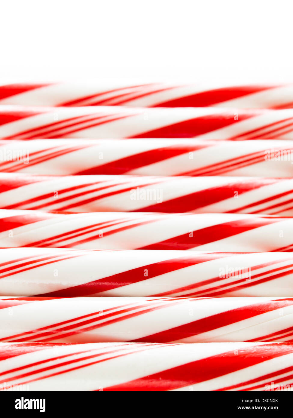 White and red peppermint candy canes in a row on white background Stock ...