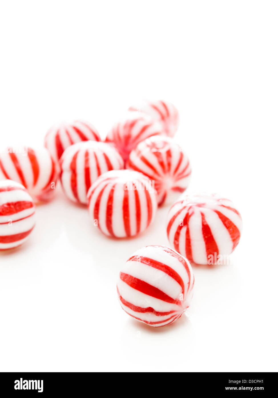 Gourmet white and red peppermint candies on white background Stock ...