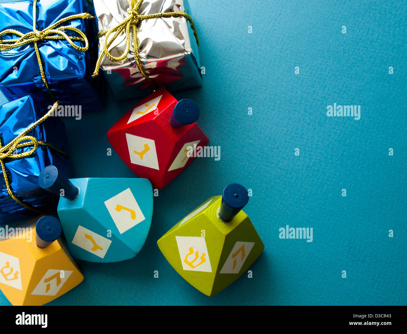 Colorful dreidels with presents on blue background Stock Photo - Alamy