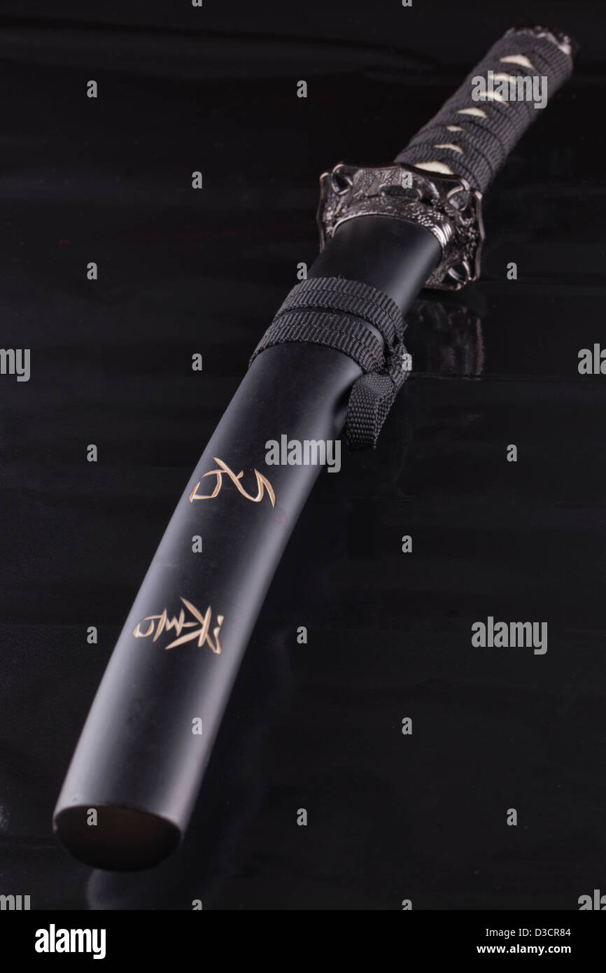 Close up of a katana over a black background Stock Photo - Alamy