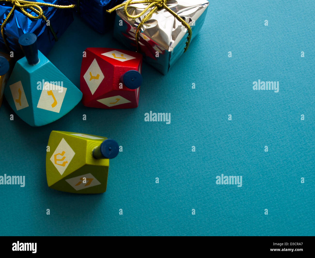 Colorful dreidels with presents on blue background Stock Photo - Alamy